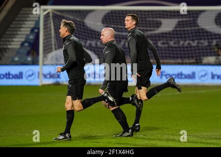 Referee Simon Hooper and both assistant referees head back after the ...