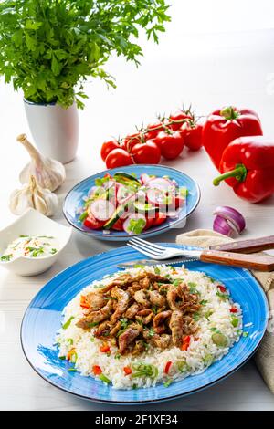 Gyros with rice and green salad and zaziki Stock Photo - Alamy