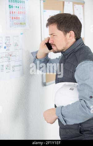 Young handsome employee with many conflicting priorities Stock Photo ...