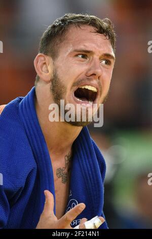 France's Loic Pietri reacts after his defeat against Canada's Antoine ...