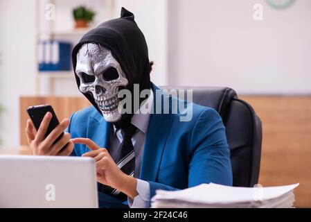 Devil businessman employee working in the office Stock Photo - Alamy