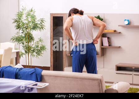 Young employee getting up late at home Stock Photo - Alamy