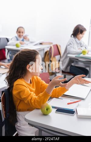 Boys and girls pupils talking near the notebook in the math class Stock ...