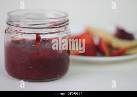 Half-cut strawberry on a golden fork isolated on a white background ...