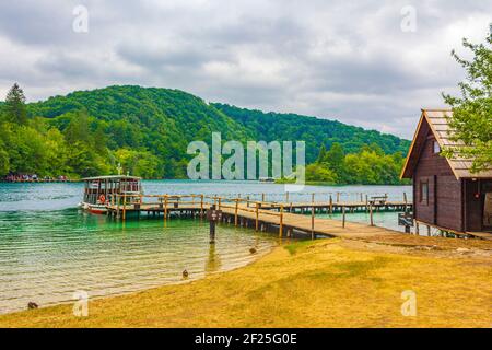 Ride electric boat across Lake Kocjak at pier in Plitvice Lakes ...