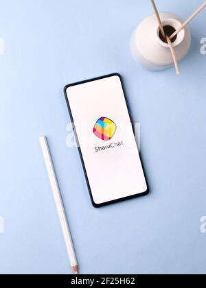 ShareChat logo on the App Store displayed on a phone screen and ...