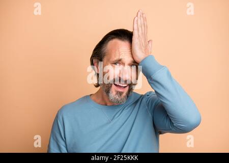 Photo portrait of disappointed guy facepalming isolated on vivid violet ...