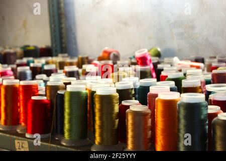 different color spools of thread for the textile industry. background ...
