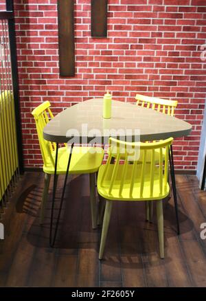 Yellow armchair and a wooden table in living room interior,white wall ...