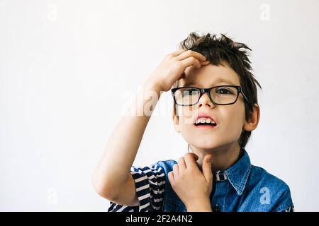Portrait of cheerful autism boy with glasses in blue shirt front a ...