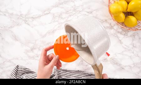 Step by step. Preparing sugar syrup for bundt cake in a saucepan Stock Photo - Alamy
