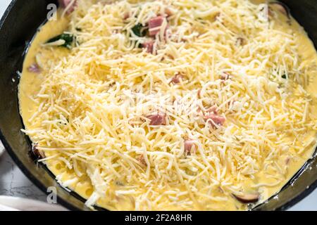 Preparing spinach and ham frittata in cast iron skillet Stock Photo - Alamy