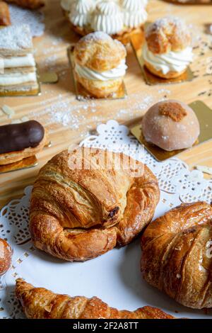 Fresh croissant, puff pastry and buttered french croissant on a plate ...
