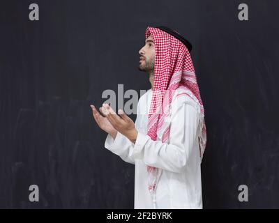 Hands Making Dua In Front of an Open Holy Quran Stock Photo - Alamy