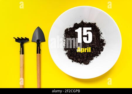 15th day of April. A small white plasticine man writing the date 15 ...