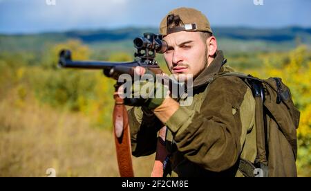 Hunter looking through scope of rifle Stock Photo - Alamy