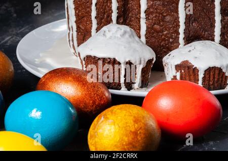 Homemade craft Easter cakes covered with white icing and multicolored ...