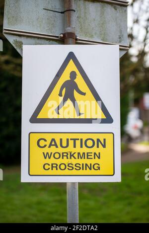 Warning sign, caution, men at work Stock Photo - Alamy