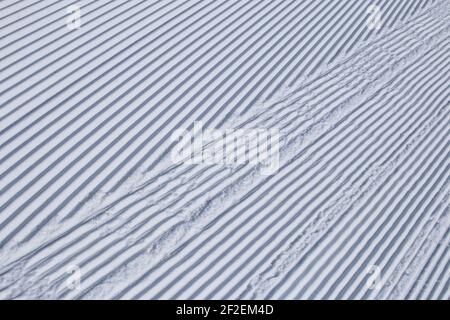 Parallel lines in freshly groomed snow at a ski resort Stock Photo - Alamy