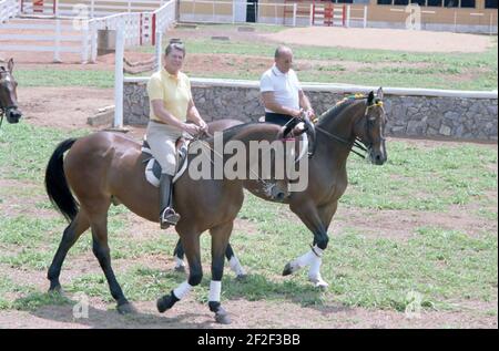 President Ronald Reagan riding horses with Queen Elizabeth II during ...