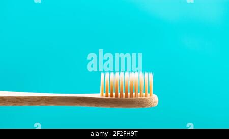 Environmentally friendly natural bamboo toothbrush on blue background ...
