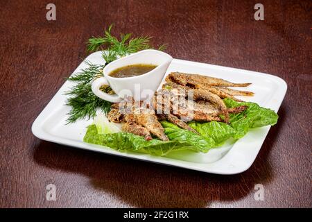 Fried barabulka fish snack with sauce Stock Photo - Alamy