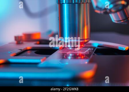 Toned photo of a backlit microscope lens in a science laboratory Stock ...