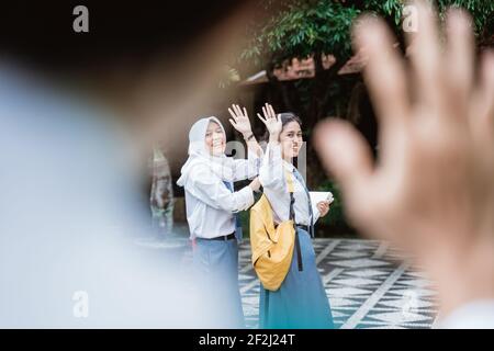 Senior man waving hand beside window in train that starting journey at ...