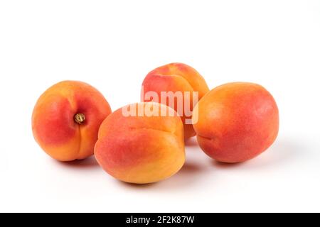 Four peaches isolated on a white background Stock Photo - Alamy