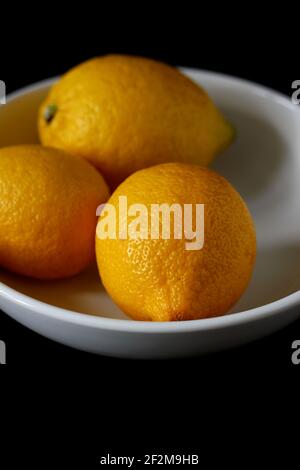 Raw fresh lemons on dark background. Harvest, agricultural concept ...