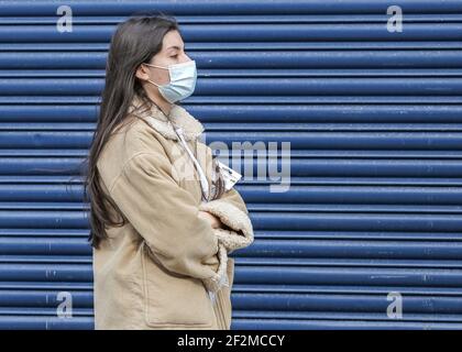 12th, March, 2021. Cheltenham, England. A member walks through the town ...