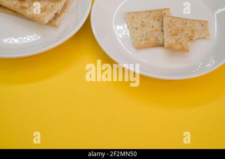 The two plates with salty crackers on a yellow surface Stock Photo - Alamy
