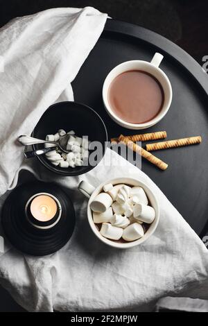 Two cups of hot cocoa or hot coffee latte with cinnamon, fir tree and ...