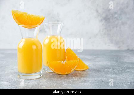 Glass pitchers of juice with slice of orange fruit Stock Photo - Alamy