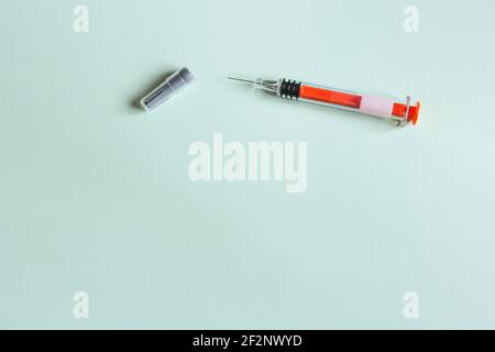 Insulin vial and uncapped syringe on white background with copy space ...