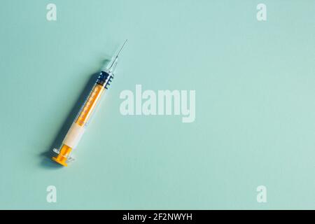 Insulin vial and uncapped syringe on white background with copy space ...