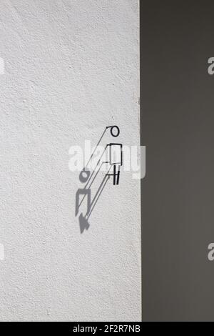 Modern sign shadow of outdoor toilet Stock Photo - Alamy