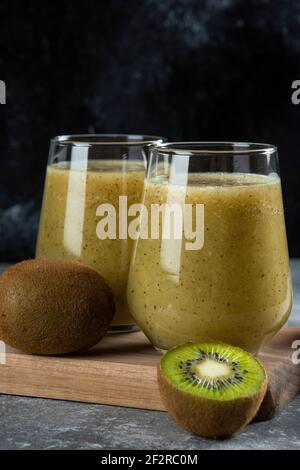 Two glass cups of tasty kiwi juice on a wooden board Stock Photo - Alamy