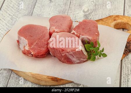 Raw pork medallion served rosemary for cooking Stock Photo - Alamy