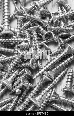 Oxidised screws, chrome-plated screws, brass-plated screws, a pile of ...