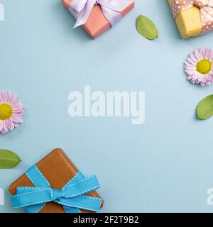 Colorful gift boxes with flowers on sky blue background. flat lay, top ...