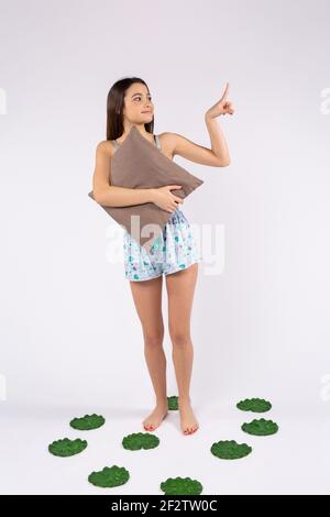 Young caucasian woman wearing sleep mask and pajama smiling doing ...