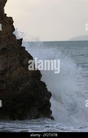 Atlantic storm waves crashing up and washing over rocks and sand on the ...