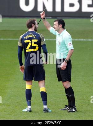 Referee Andrew Madley shows a yellow card to Chelsea goalkeeper Djordje ...