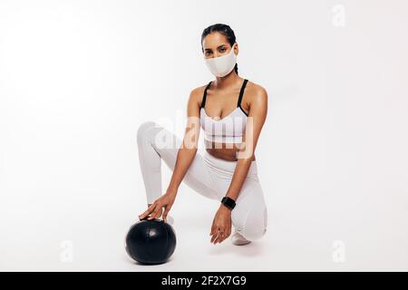 fitness woman relaxing after workout listening to music on headphones ...