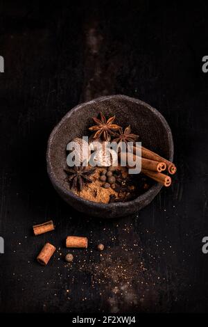 Anise stars, cloves and cinnamon sticks on grey wooden background ...