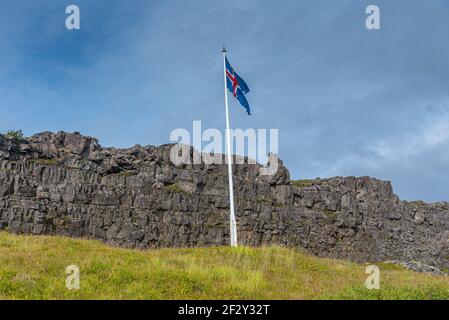 Flagpole with flag of Iceland at former Althingi site at Thingvellir ...