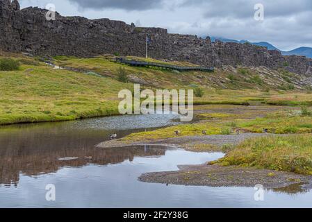 Flagpole with flag of Iceland at former Althingi site at Thingvellir ...