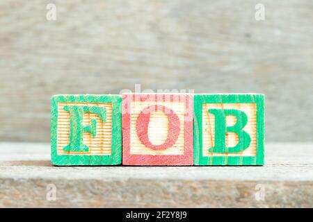 Alphabet letter in word FOB (abbreviation of free on board) on wood ...