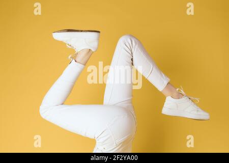 Inverted womens legs sneakers fashion studio street style Stock Photo ...